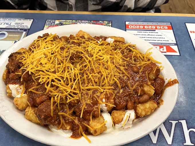 Tater tots buried under chili, sour cream, and a generous snowfall of shredded cheddar, this dish came to win.