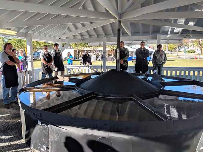 Nothing says community like a crew of apron-wearing folks gathered around a 15-foot pan, ready for business.