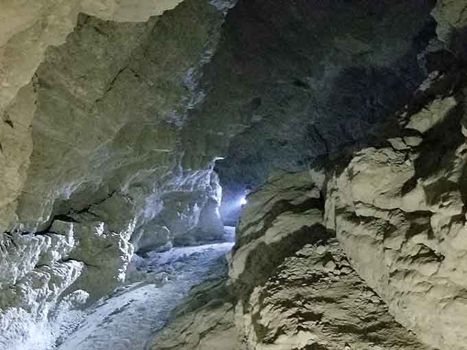 Compressed mudstone forms narrow passages that adventurous souls squeeze through, discovering hidden desert secrets within.
