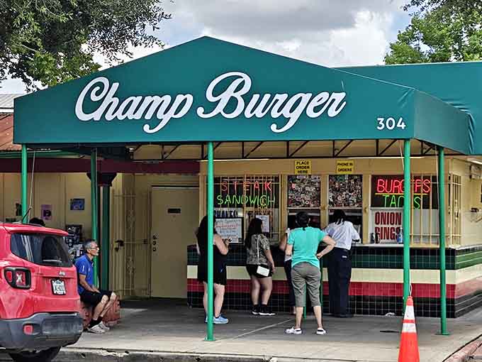 That teal awning with cursive lettering and a line of hungry customers at the window is the most convincing restaurant review you'll ever see.