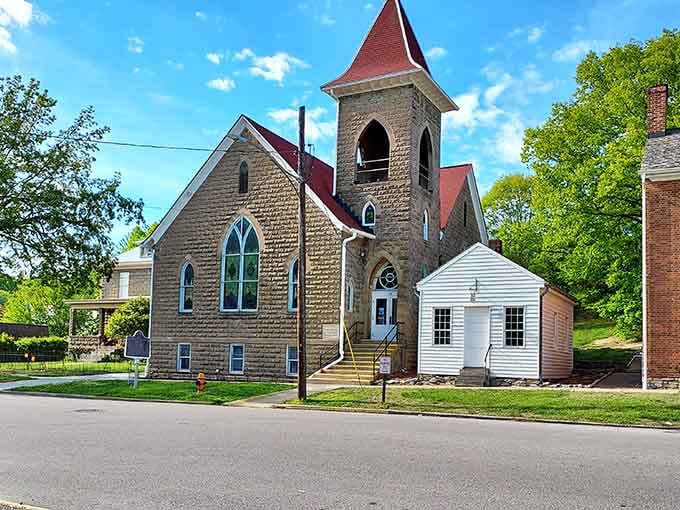 This stone church stands solid and beautiful, its red roof a beacon for anyone seeking architectural grace and small-town serenity.