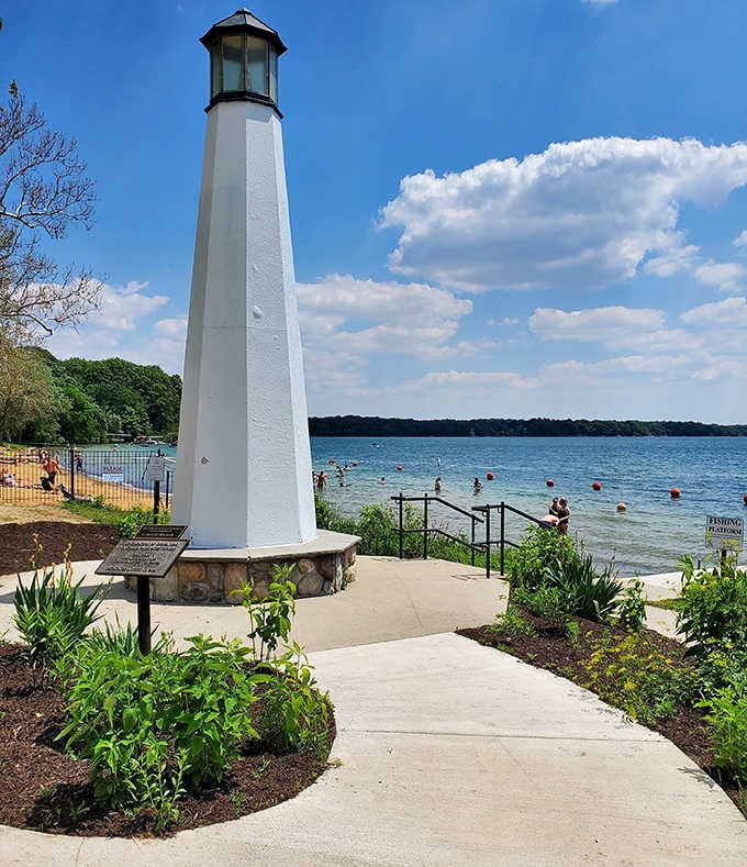 Culver's bright white lighthouse stands tall against Lake Maxinkuckee's sparkling blue water, looking like it wandered in from a New England postcard.