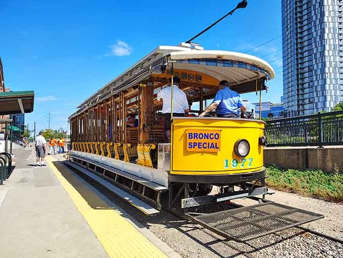 The open-air Bronco Special trolley rolls along the South Platte on a bluebird Denver day, pure joy on rails.
