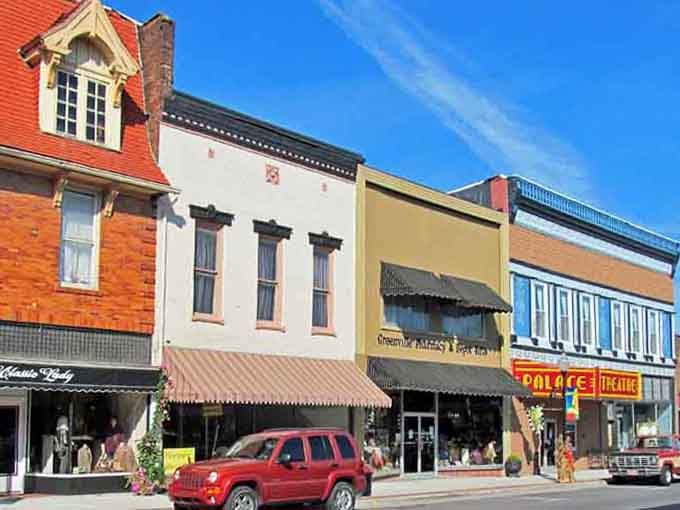 The Palace Theatre marquee pops against Greenville's brick storefronts like a neon exclamation point on an otherwise perfectly composed sentence.