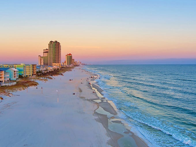 Cotton-candy skies stretch endlessly over sugar-white sand, proof that Alabama's Gulf Coast sunsets are genuinely world-class.