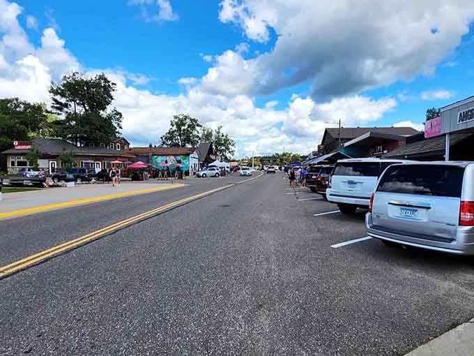 Summer sunshine bathes main street where families stroll and ice cream cones melt faster than worries.