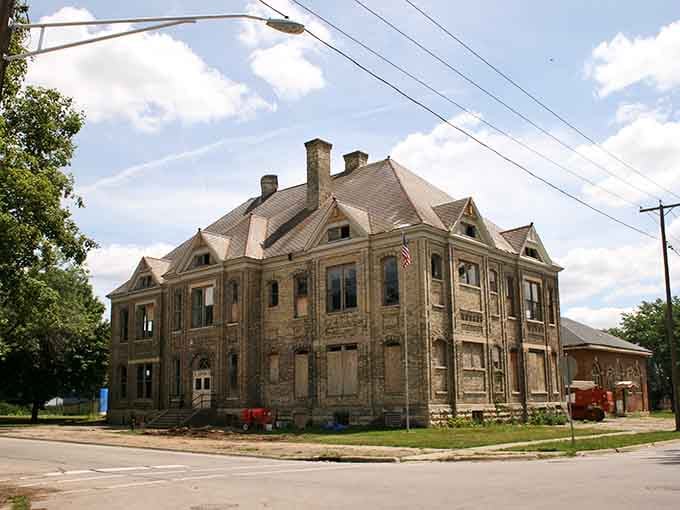 A stately limestone building stands at a Rockford corner, its grand Mansard roofline hinting at stories this old town still holds.