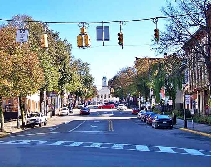 That white cupola at street's end draws your eye like a lighthouse guiding ships through small-town tranquility.