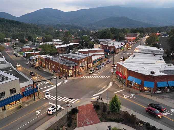 From above at dusk, Black Mountain's downtown crossroads sparkles with shop lights while the mountains wrap the whole scene in drama.