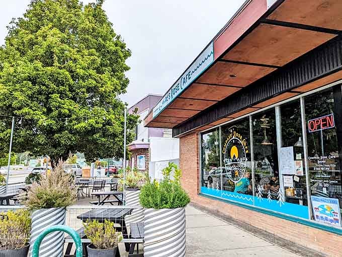 The Compass Rose Cafe's cheerful turquoise signage and outdoor planters make Brookings feel like a town that genuinely loves breakfast.