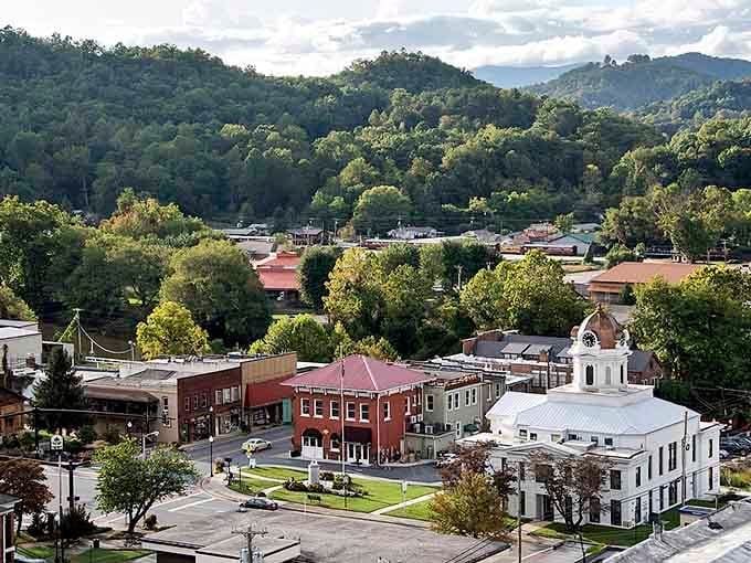 The town nestles into green valleys with that classic white courthouse anchoring the historic downtown square perfectly.