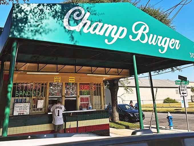 Sunshine, a bold teal canopy, and neon signs advertising burgers and onion rings &mdash; Champ Burger on Sampson Street is Houston's happiest corner.