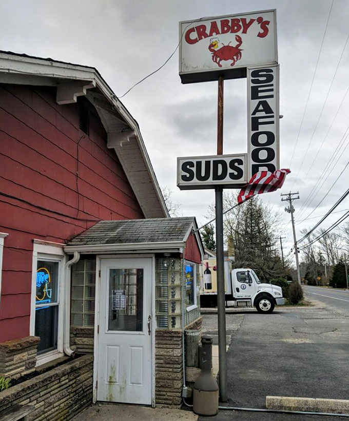A weathered door, a stone foundation, and a sign promising seafood and suds tell the whole story of this beloved roadside gem.