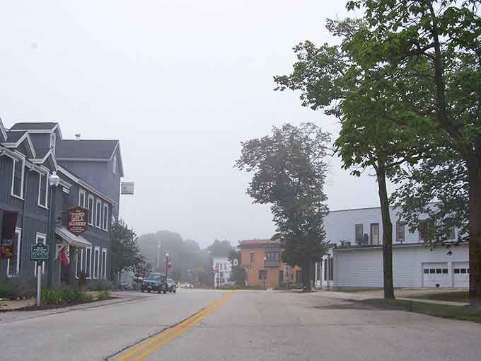 Morning fog softens Elkhart Lake's quiet streets into something that looks borrowed straight from a Midwest watercolor painting.