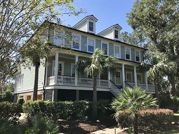 That wide wraparound porch is basically nature's invitation to sit down, slow down, and stay a whole lot longer.