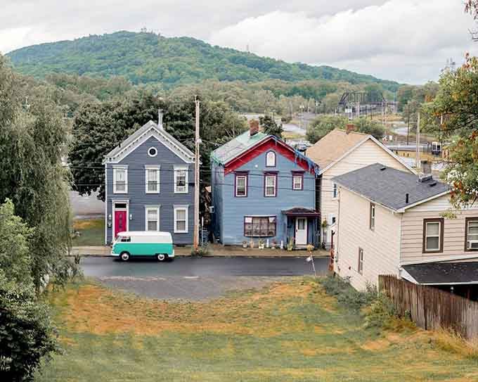 Painted houses lined up like a box of crayons, with that vintage van adding a splash of nostalgia to the scene.