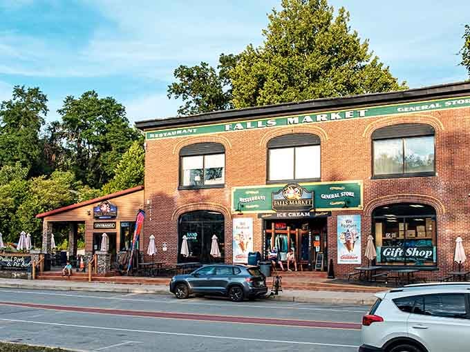 Falls Market's green signage and warm brick glow in the late afternoon sun, practically waving you in for ice cream and good company.