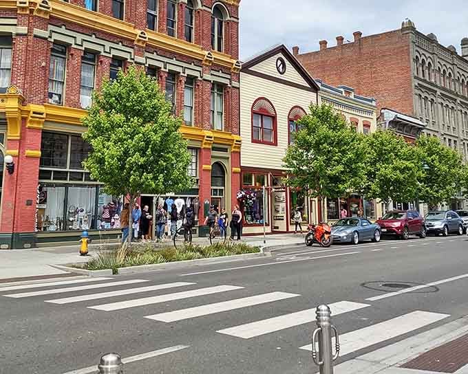 Port Townsend's colorful downtown streetscape, buzzing with pedestrians and a red motorcycle, feels like a living, breathing piece of history.