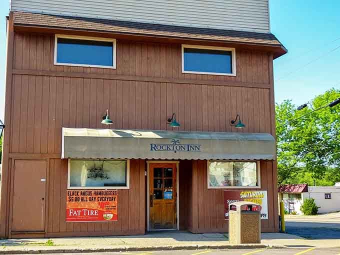 The Rockton Inn's wooden exterior and glowing barn lights give off serious "best burger you didn't know you needed" energy.