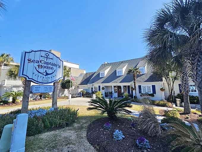That anchor-adorned sign standing proudly among the palms and winter blooms says everything worth knowing about this Myrtle Beach landmark.