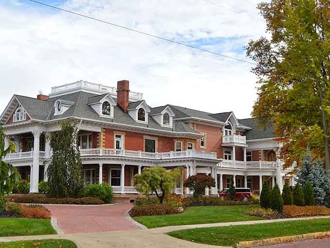Sebring's grand Victorian mansion sits beneath autumn trees, its wraparound porches and brick facade radiating a quiet, unhurried elegance.