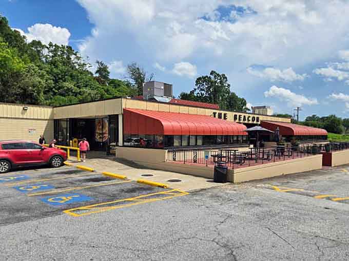 That sweeping red canopy stretching across the full facade confirms The Beacon isn't just a restaurant, it's a South Carolina landmark.