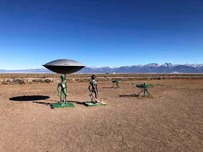 Metal aliens stand guard beneath their flying saucer, welcoming earthlings to this quirky outpost of cosmic curiosity and wonder.