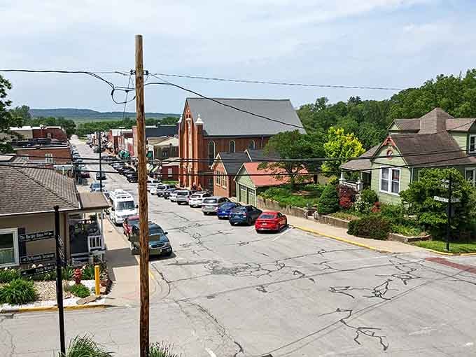From this elevated view, Weston's main street stretches toward rolling green hills, with a handsome church steeple anchoring the whole beautiful scene together.
